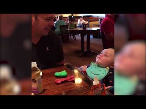 Dad Squirts Milk Into Baby's Mouth
