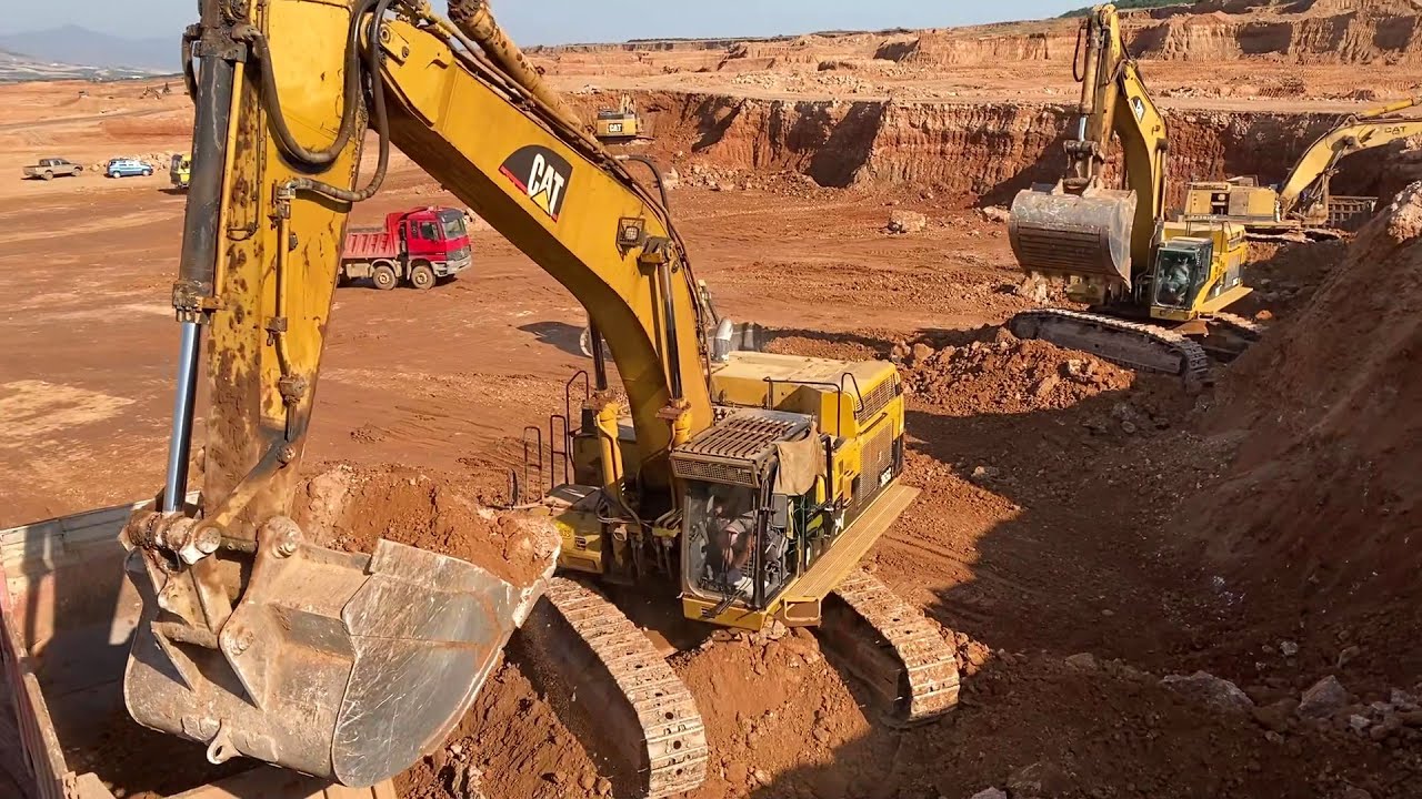 Four Caterpillar Excavators Loading Mercedes And MAN Trucks On Huge ...