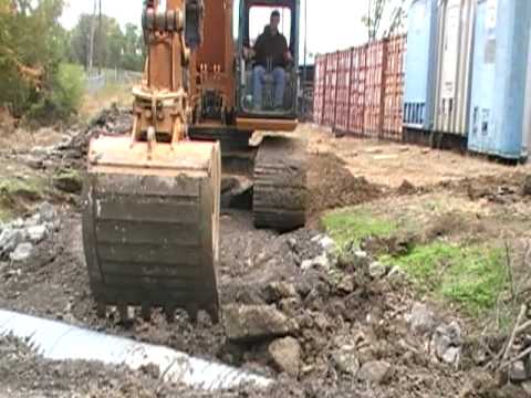 Case CX210 Excavator backfilling a drain tile - YouTube