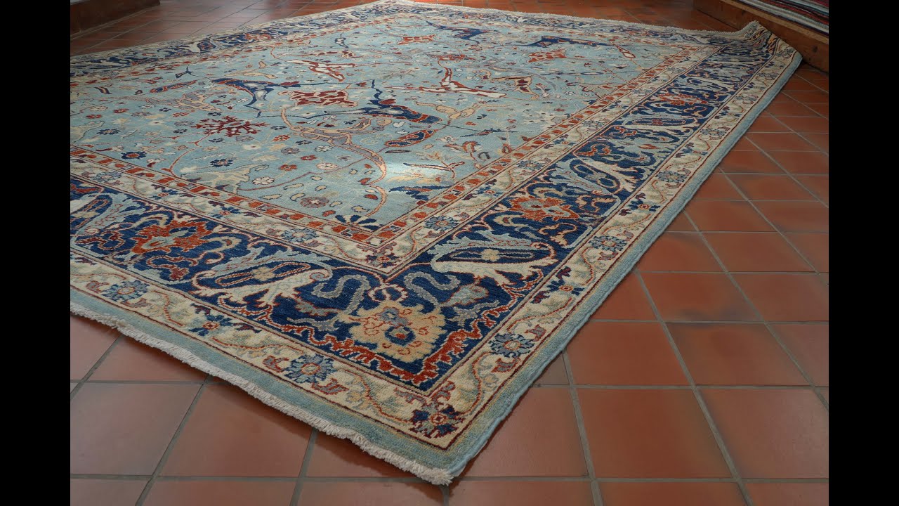Handmade Afghan Aryana carpet with blues, rust and cream colourings ...
