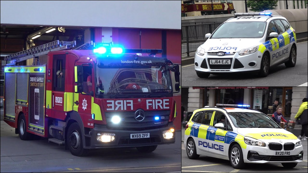 Fire engine and police cars responding with siren and lights in London ...
