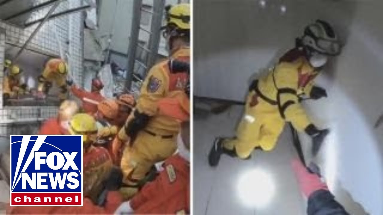 Rescuers evacuate leaning building as aftershocks hit Taiwan - YouTube