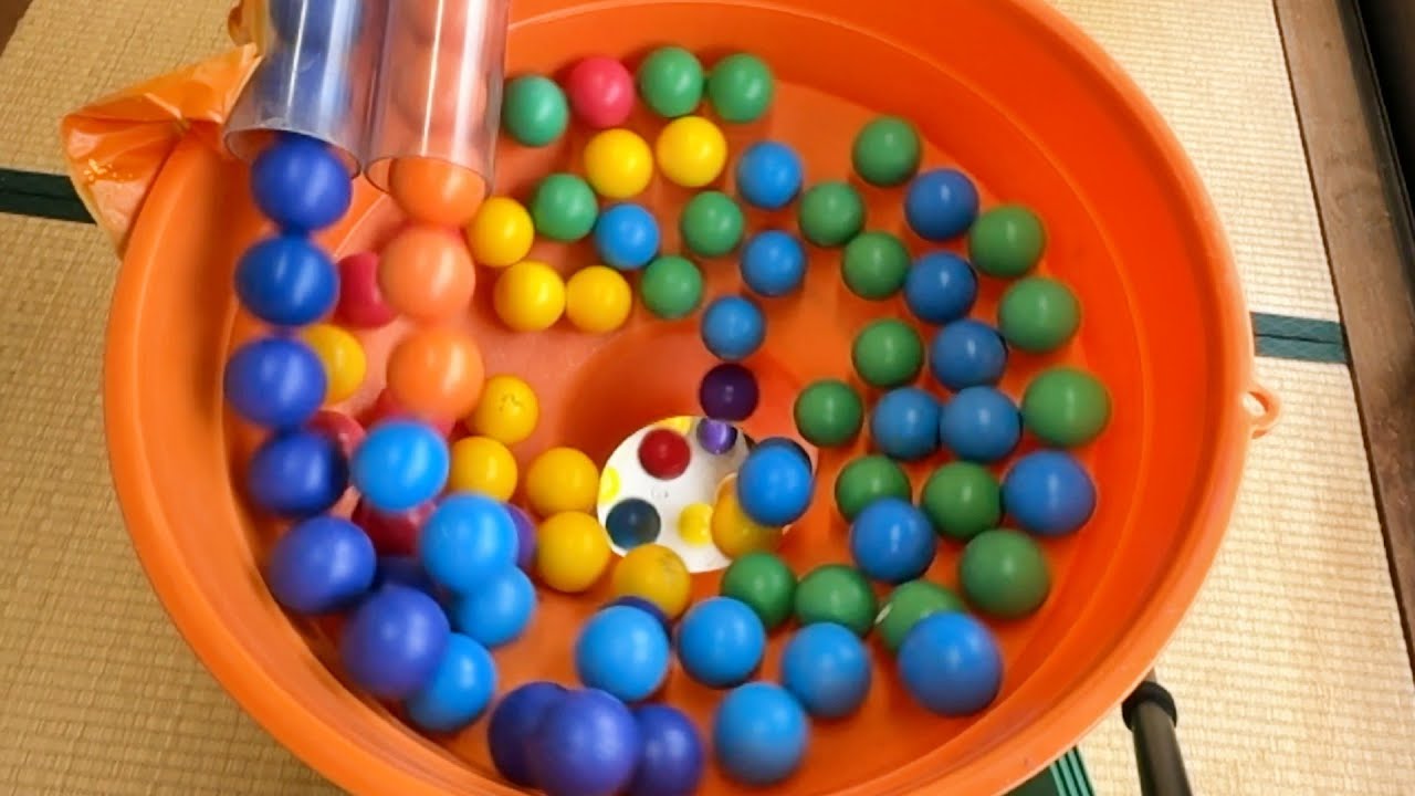 Make a marble run course using two transparent long pipes and a large ...