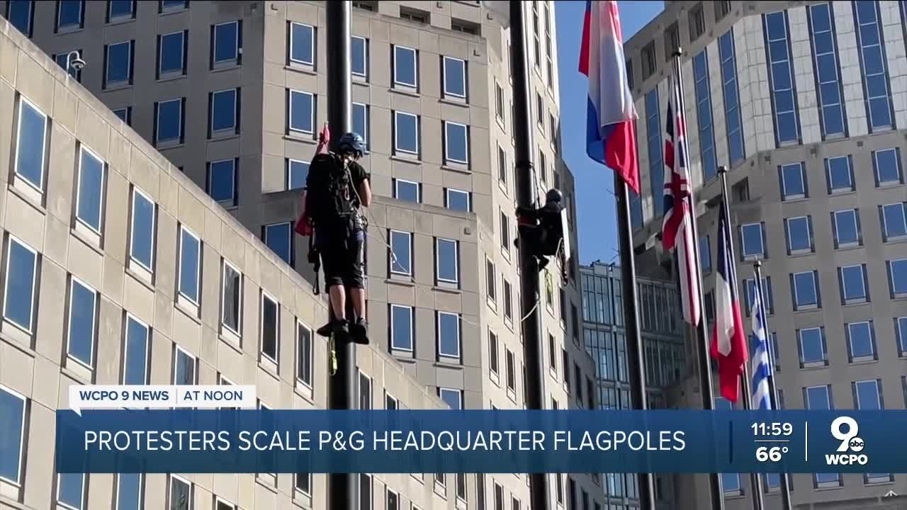 Protesters scale flagpoles outside Procter & Gamble headquarters - YouTube