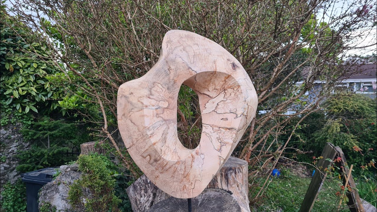 chainsaw carving a Mobius strip sculpture - YouTube
