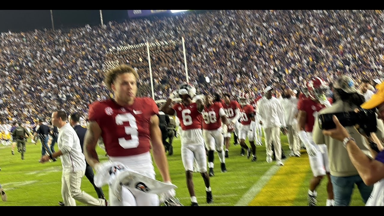Alabama players head to the locker room as LSU fans rush the field and ...