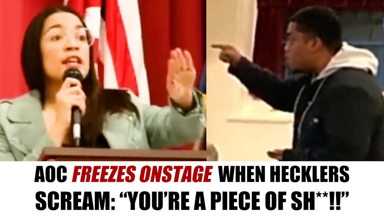 AOC FREEZES on stage when heckler erupts at her: "You're a piece of ...