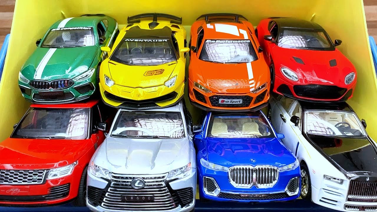 Box full of various miniature cars Peugeot, Jaguar, Pagani, Hyundai ...