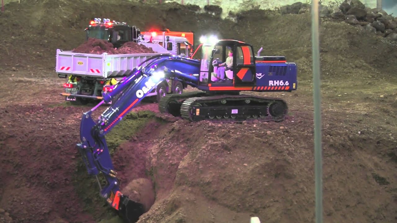 RC EXCAVATOR DAMITZ RH 6.6 LOADING DUMP TRUCKS AT THE CONSTRUCTION SITE ...