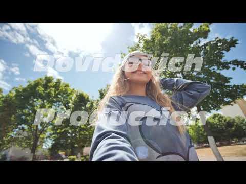 Beautiful twelve-year-old teenager girl takes a selfie with a video camera on the background of sun