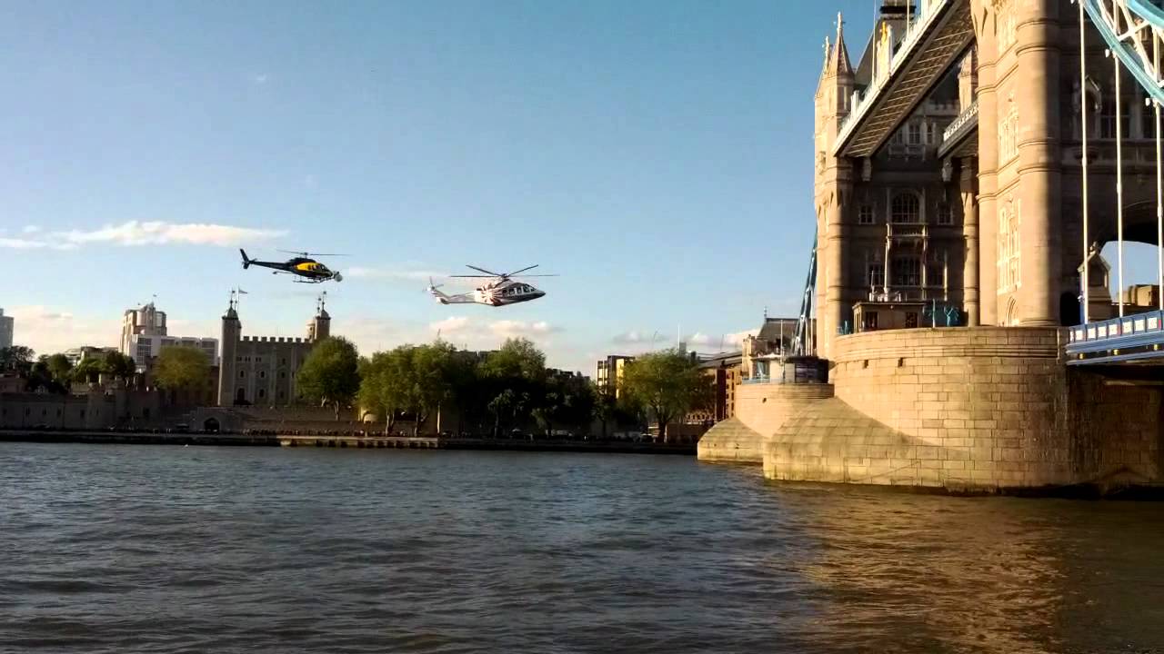 Two helicopters flying through Tower Bridge London - YouTube