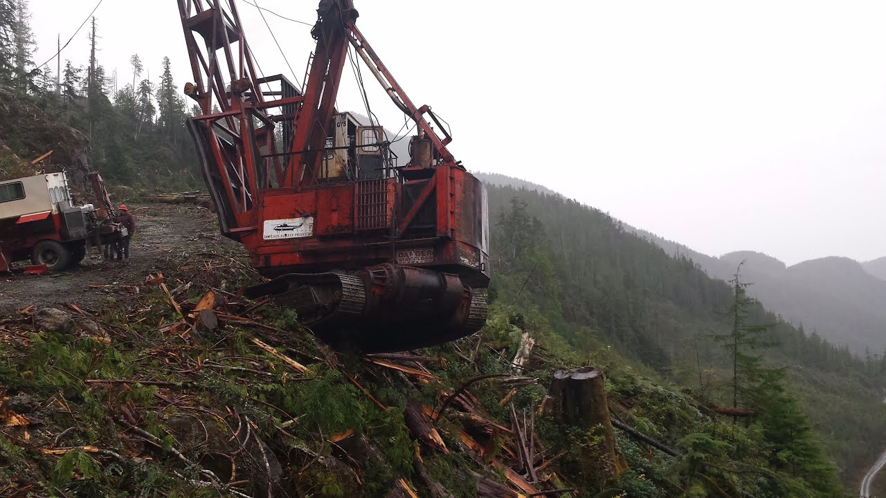 Grapple yarder rolls off road - YouTube