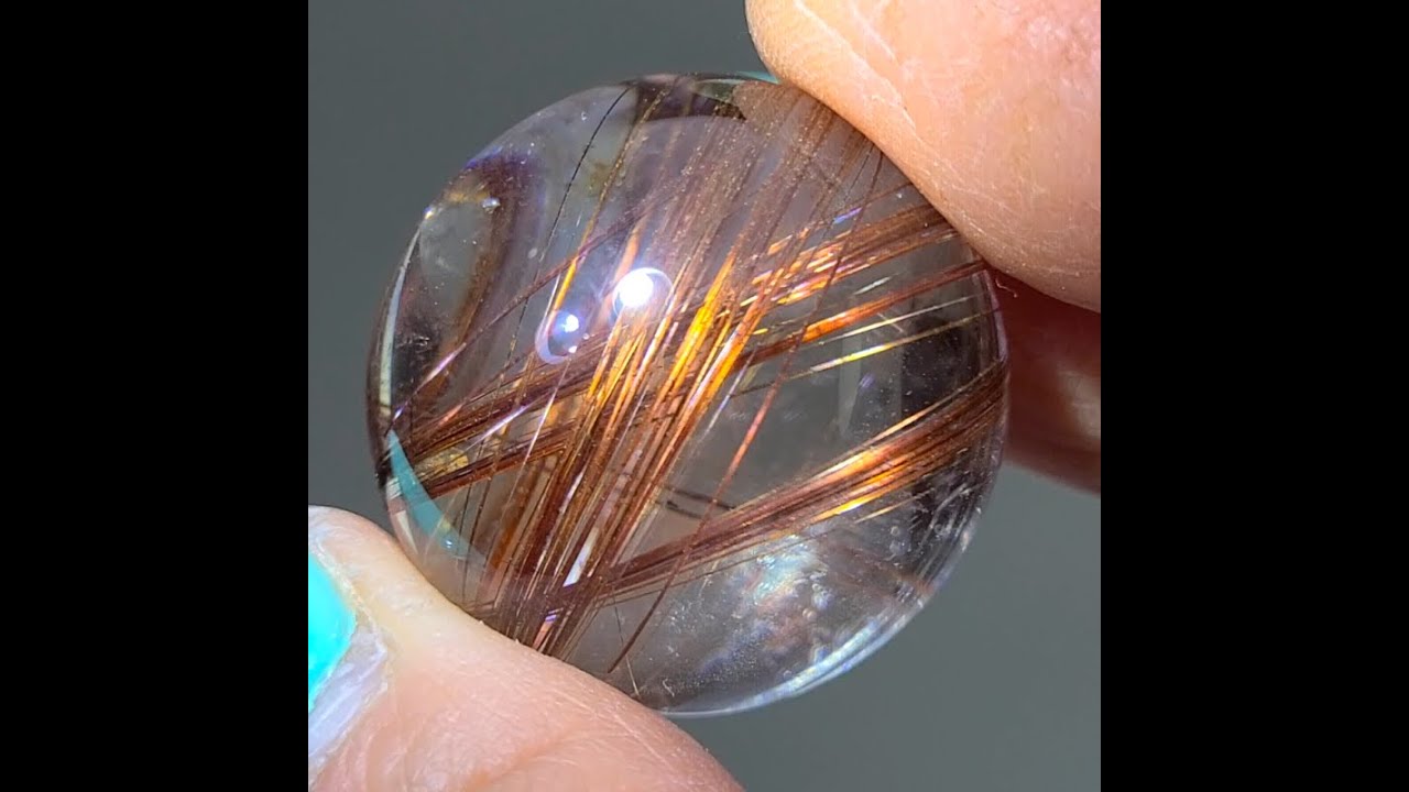 Copper rutilated quartz sphere with rainbows and great clarity - YouTube
