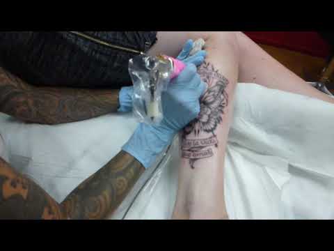 Monica tattoos a  butterower or maybe a flowerfly....