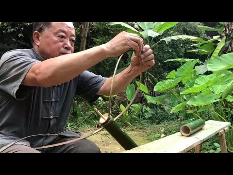 A rural grandfather made a table tennis toy gun with two bamboo ...