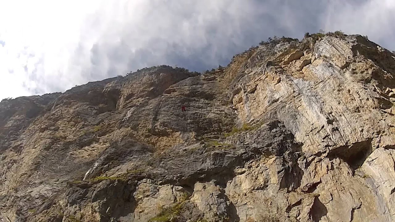 Reverse View of Base-Jumping Off Rocky Cliff - YouTube