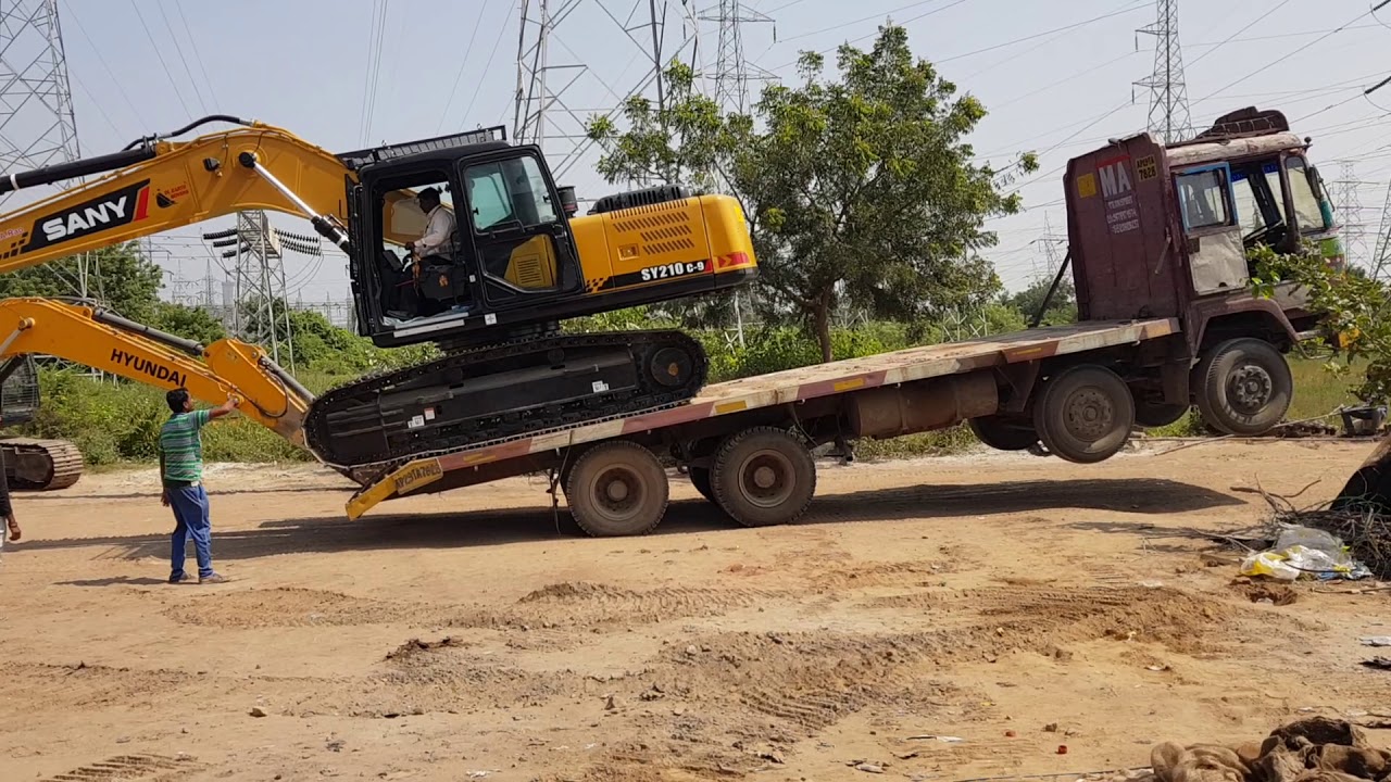 Loading of an excavator Sany 210 on to trolley - YouTube