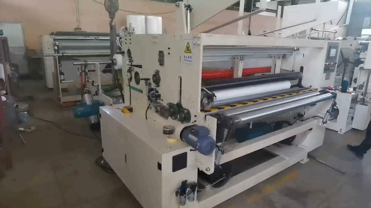 Non woven fabric roll rewinding perforate convert machine - YouTube