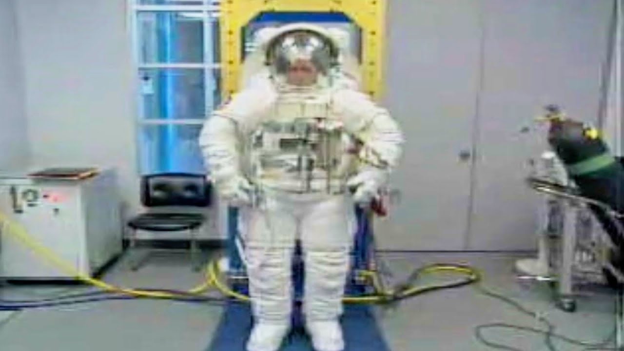 Woman dons the EMU spacesuit - YouTube