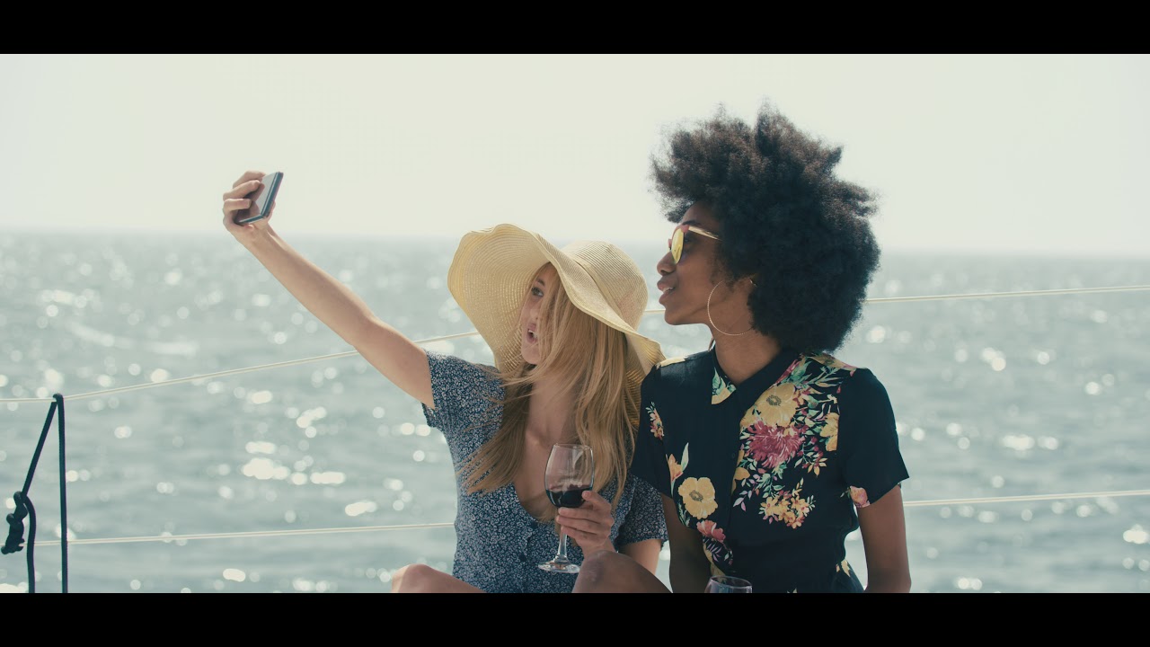 two women taking a selfie while on a boat by Omri Ohana Artgrid ...