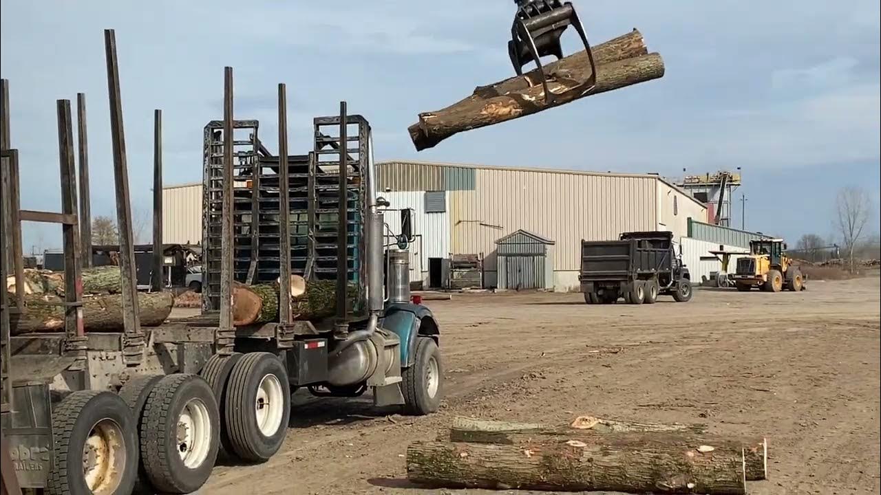 Log truck .. Unloading Logs - YouTube