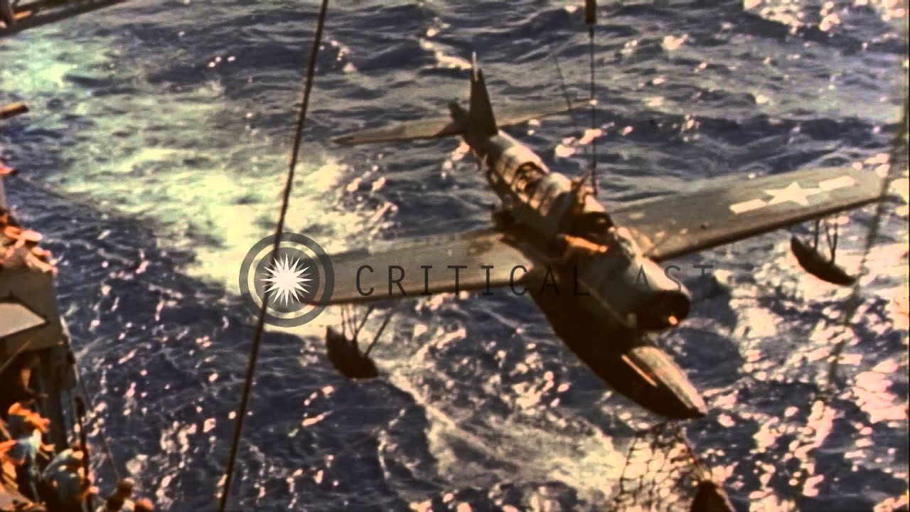 Cruiser USS Chester recovers her OS2U Kingfisher Floatplane, while ...