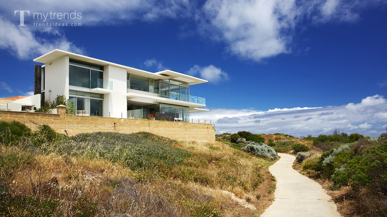 Coastal home with large roof overhangs and protected limestone tiled ...