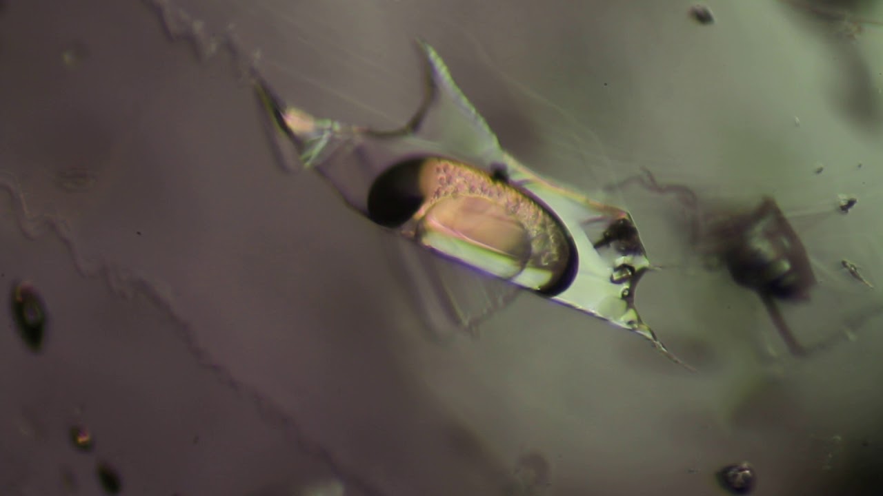 Liquid and gas inclusion - topaz - YouTube