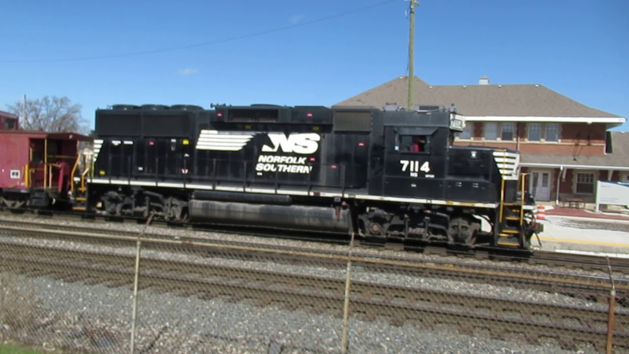 NS 7114 pulling NS caboose and local freight train heading East at ...