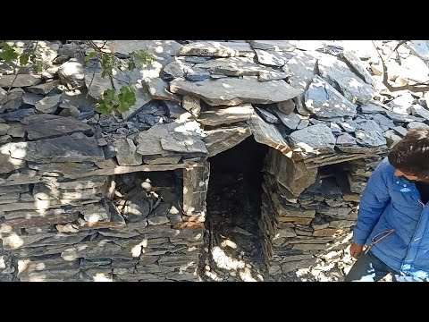 Building a Stone dugout house with a fireplace in 7 days/Bushcraft ...