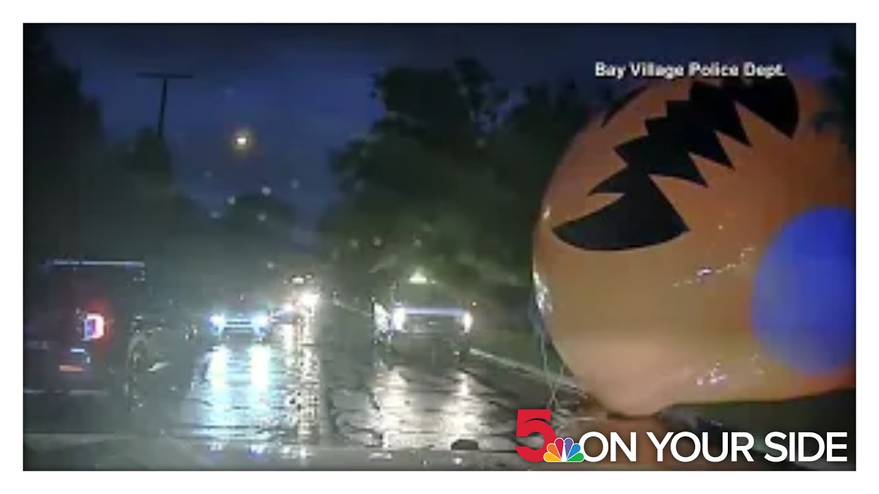 Ohio police officers wrestle giant inflatable pumpkin decoration - YouTube