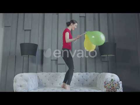 excited birthday girl jumping on sofa at home by alona2018 preview ...