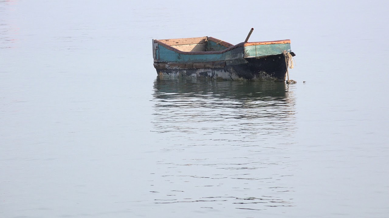 Small boat floating on the ocean. - YouTube