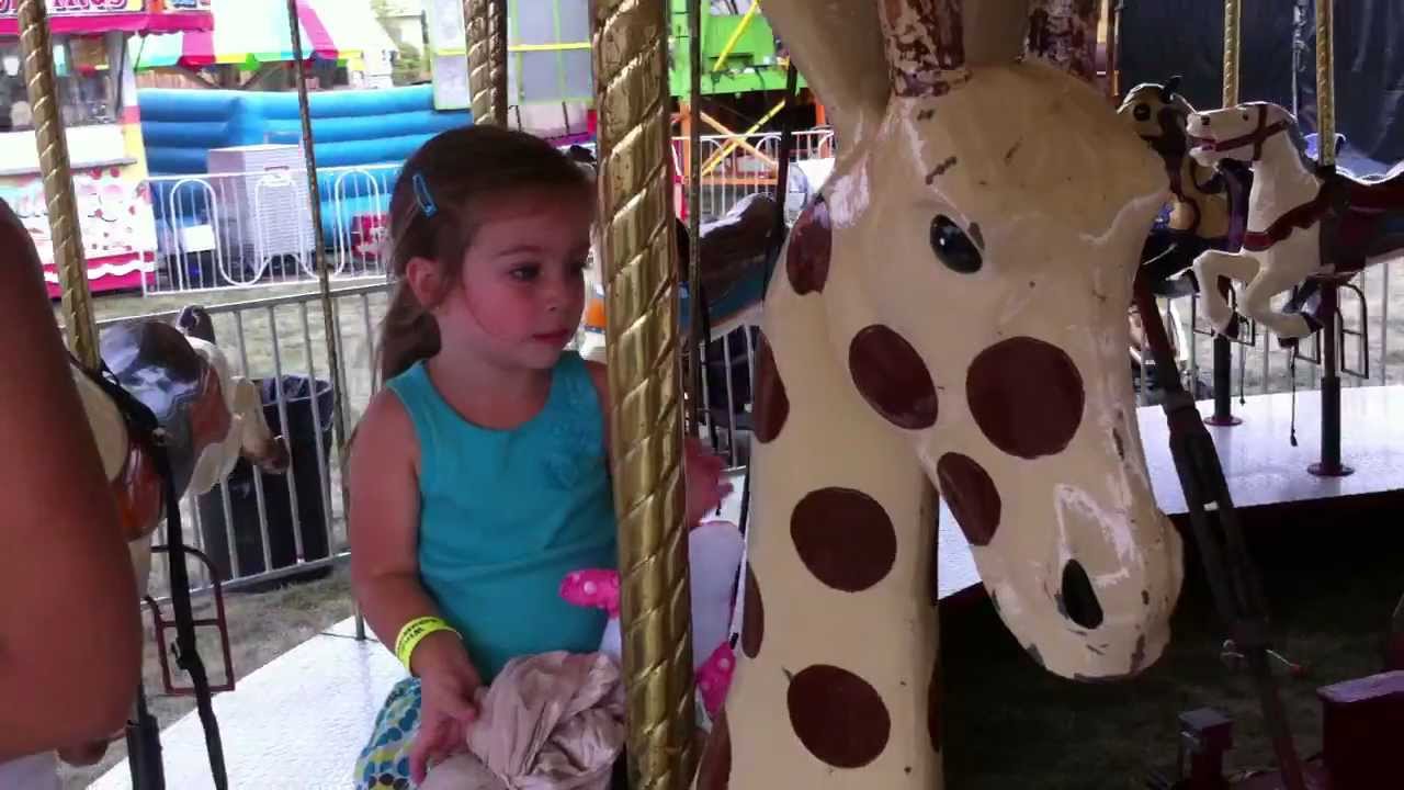 Ella, Mom, Dad, and Dom on Merry Go Round - YouTube