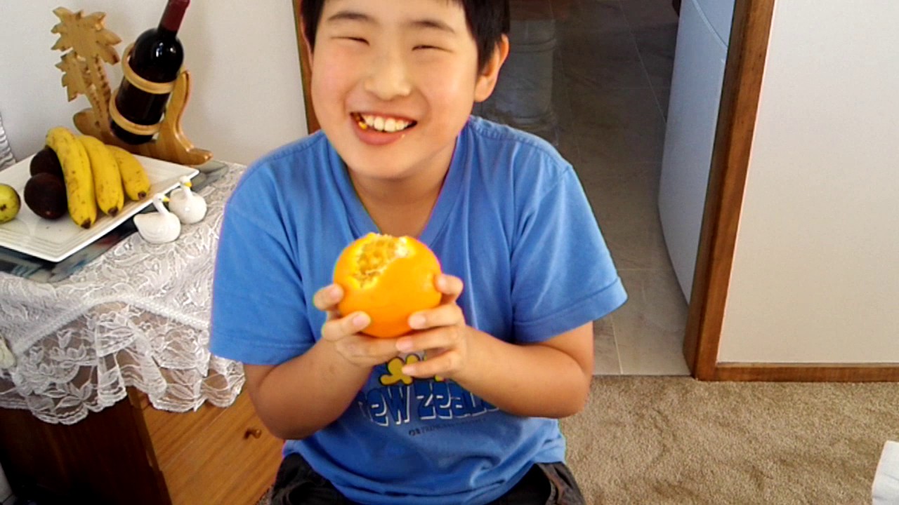 A boy eating an orange whole! - YouTube