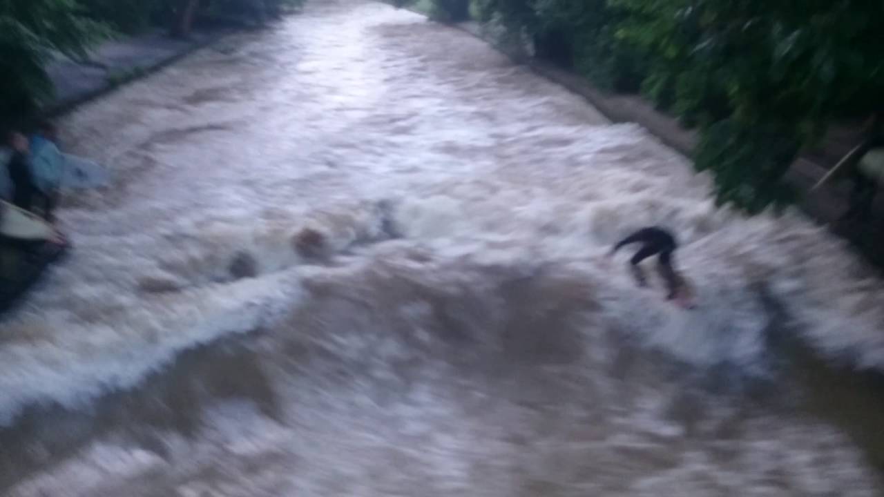 Surfing in the Isar River going through the English Garden in Munich ...