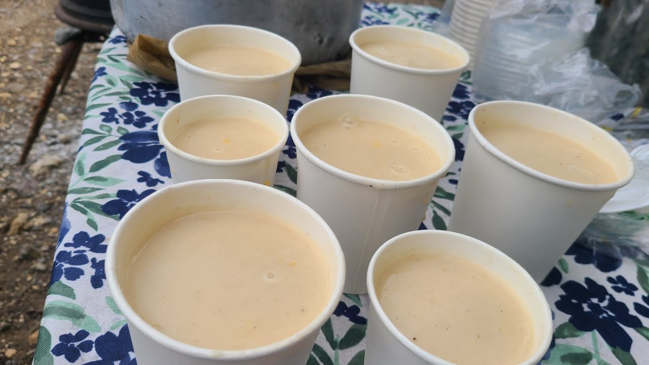 Cooking some corn hominy porridge before the hurricane in di street ...