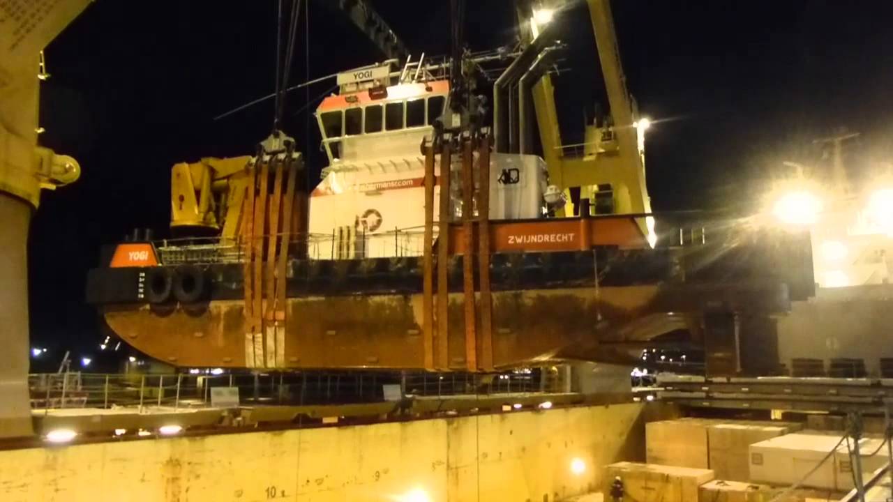 Loading of multicat Yogi on heavy lift vessel Trina - YouTube