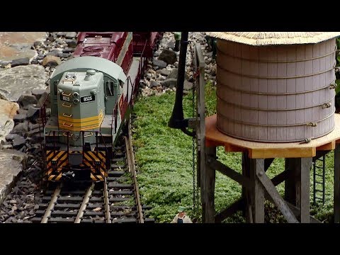 Couple creates tiny model train world in backyard