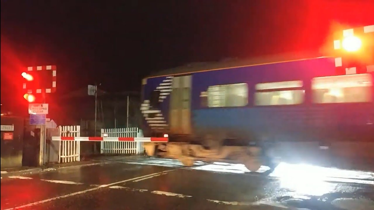 Scotrail class 158 heads west at Dingwall Mill Street level crossing ...