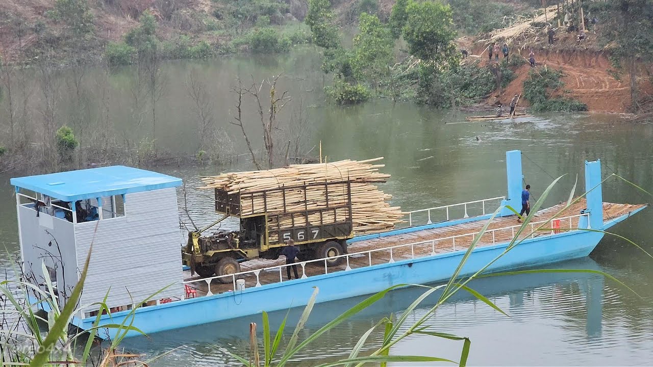 Crossing the river on a homemade ferry carrying a heavy timber truck ...
