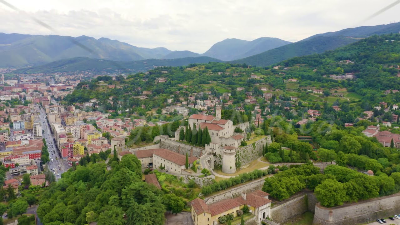 Brescia, Italy. Castello di Brescia. Flight over the city in cloudy ...