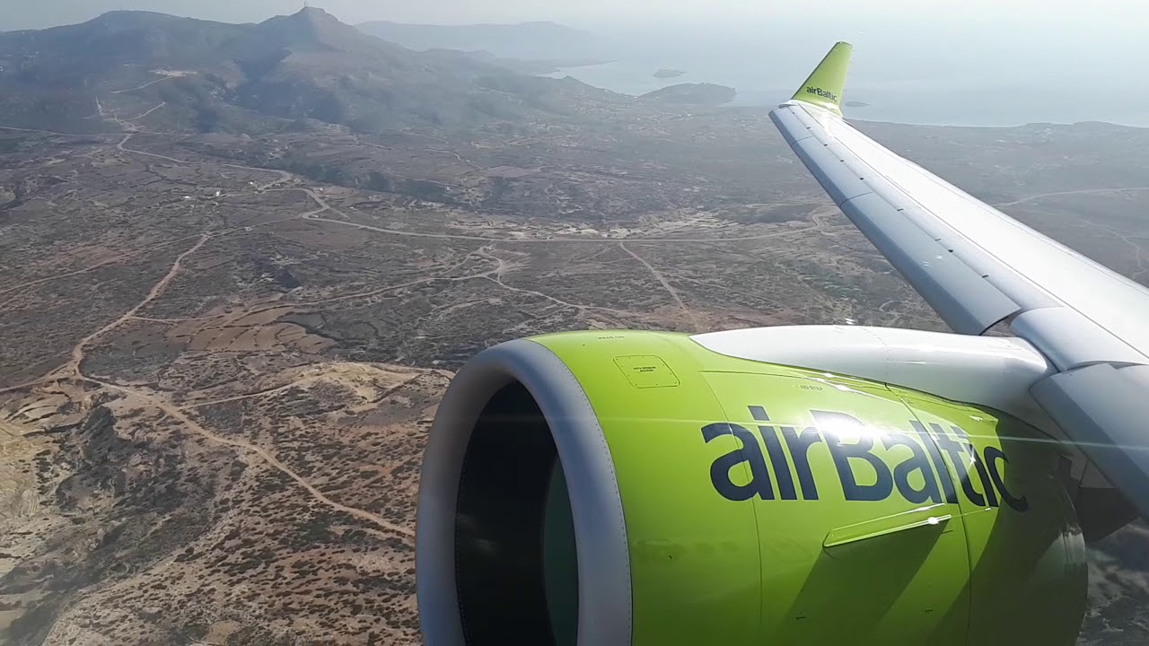 Wing view Air Baltic Airbus A220 takeoff from Karpathos Greece 10-2018 ...