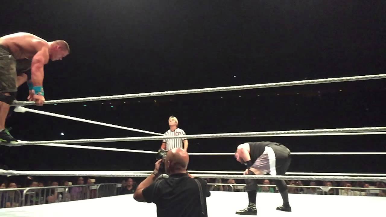 Kevin Owens counters a top rope leg drop from John Cena into a sit down ...