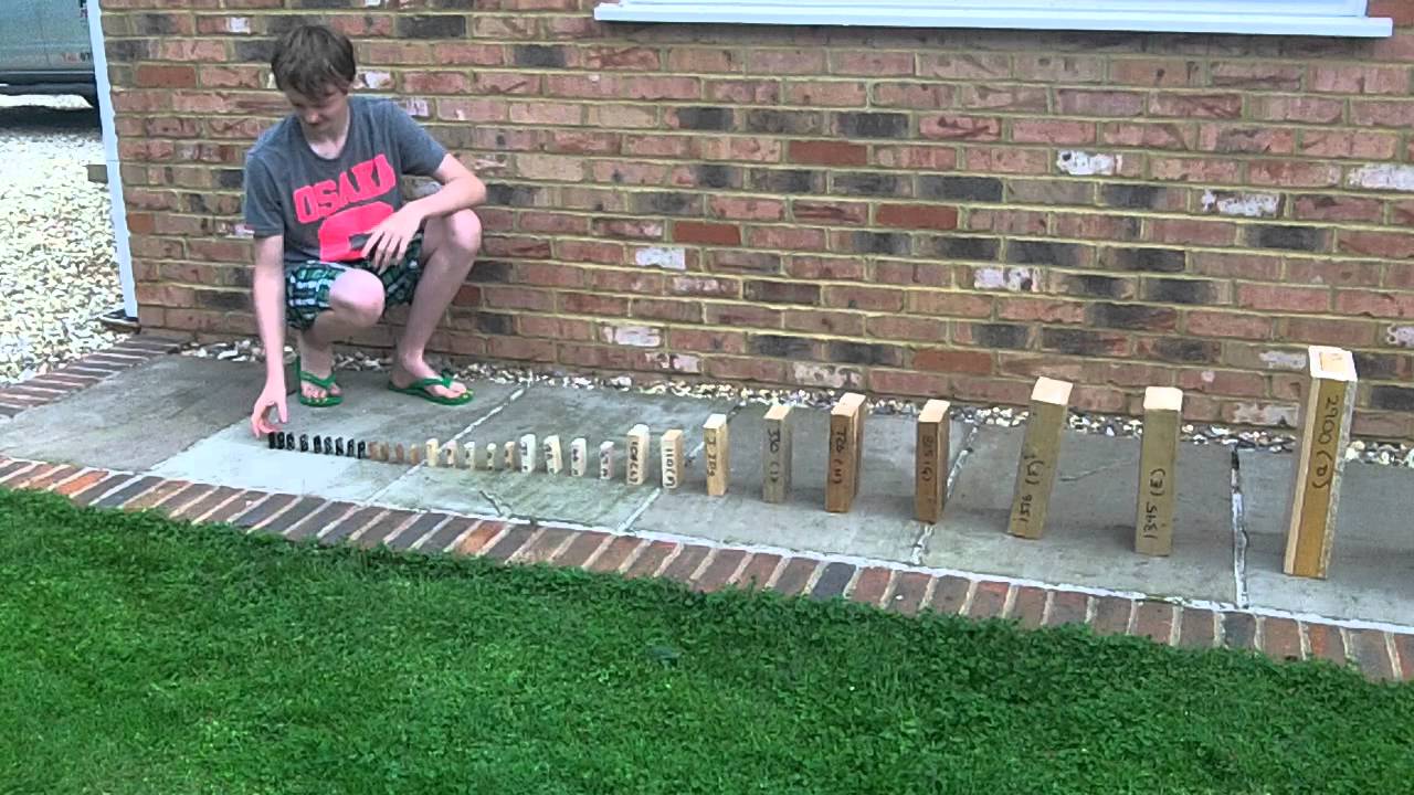dominoids - how to knock over a 16kg domino with a 4g domino - YouTube