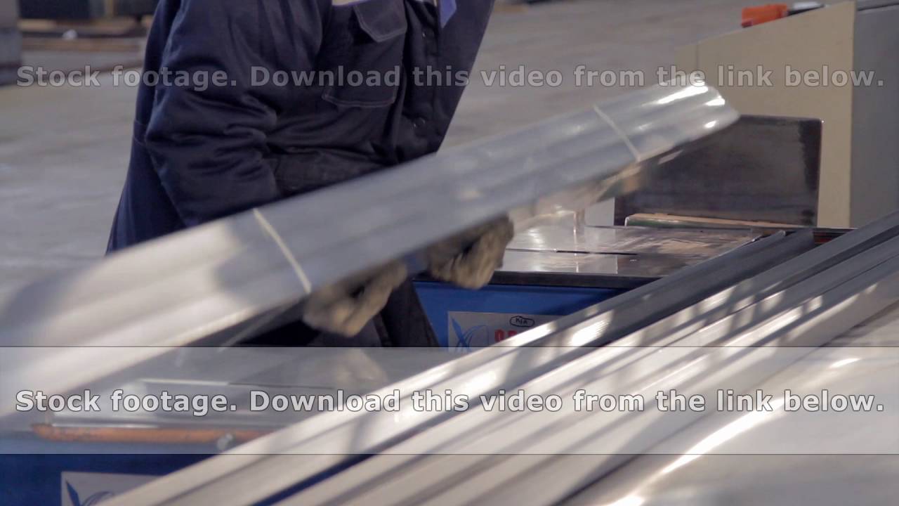 worker is packing metal beams close-up - YouTube