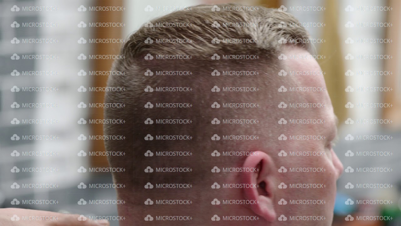 Men's haircut in Barbershop. Close-up of master clipping a man with ...