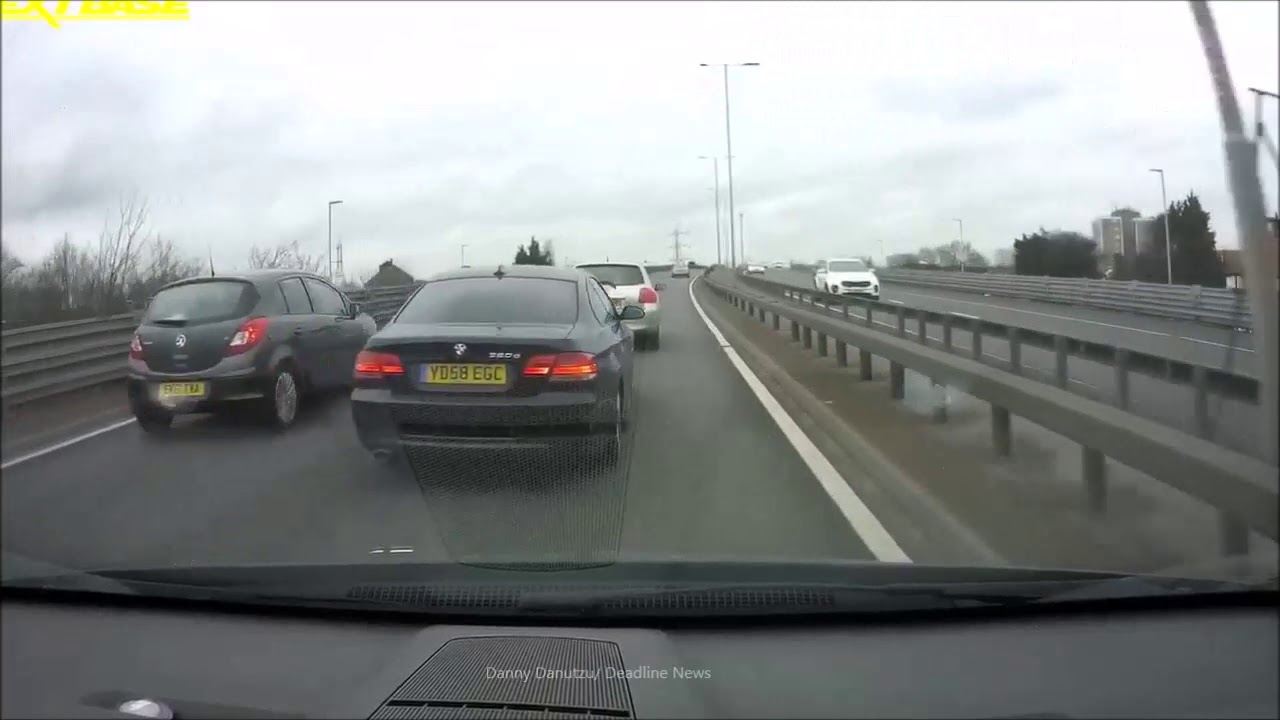 Moment undertaking BMW swerves between cars, almost causing high-speed ...