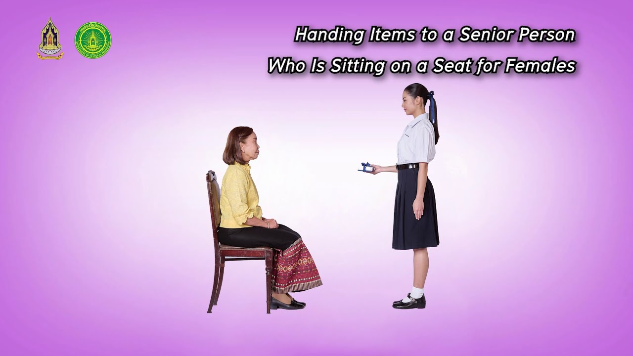 Handing items to a senior person who is sitting on a Seat (Female ...