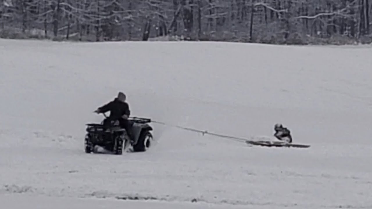 Riding the four-Wheeler in the snow and pulling Wade on the golf cart ...
